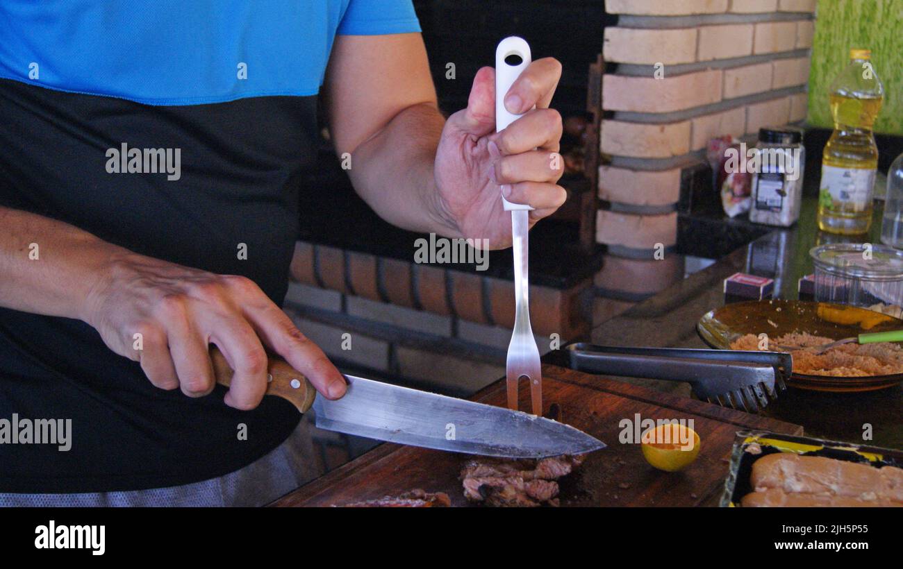 Man cutting meat hi-res stock photography and images - Alamy