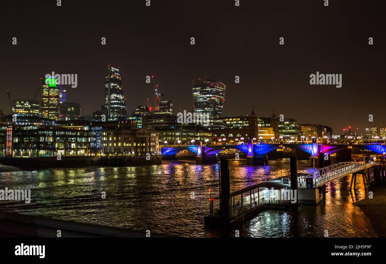 A night time shot of Bankside Embankment pier and Southwark Bridge with ...