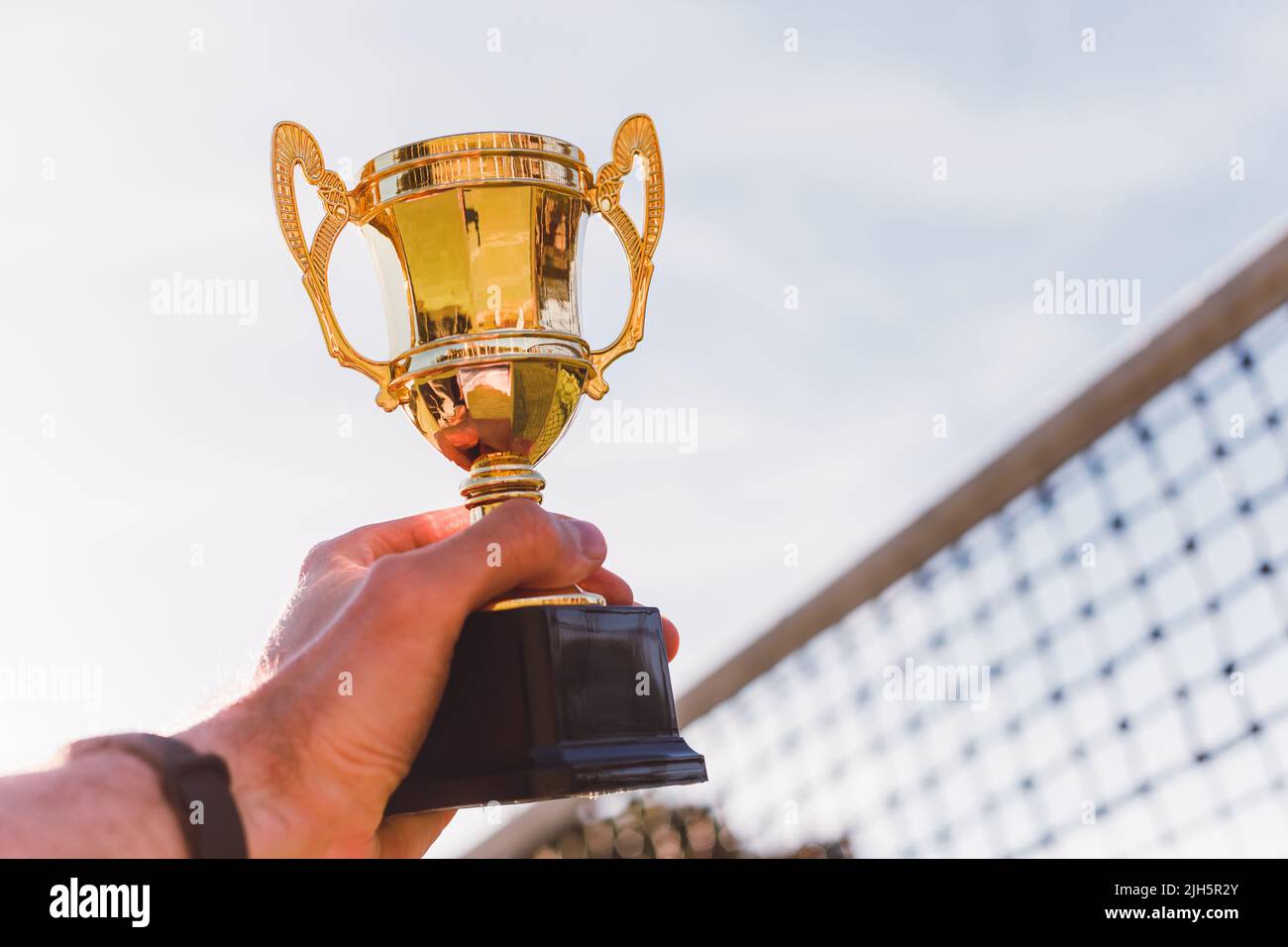 Badminton championship cup in hand hi-res stock photography and images ...