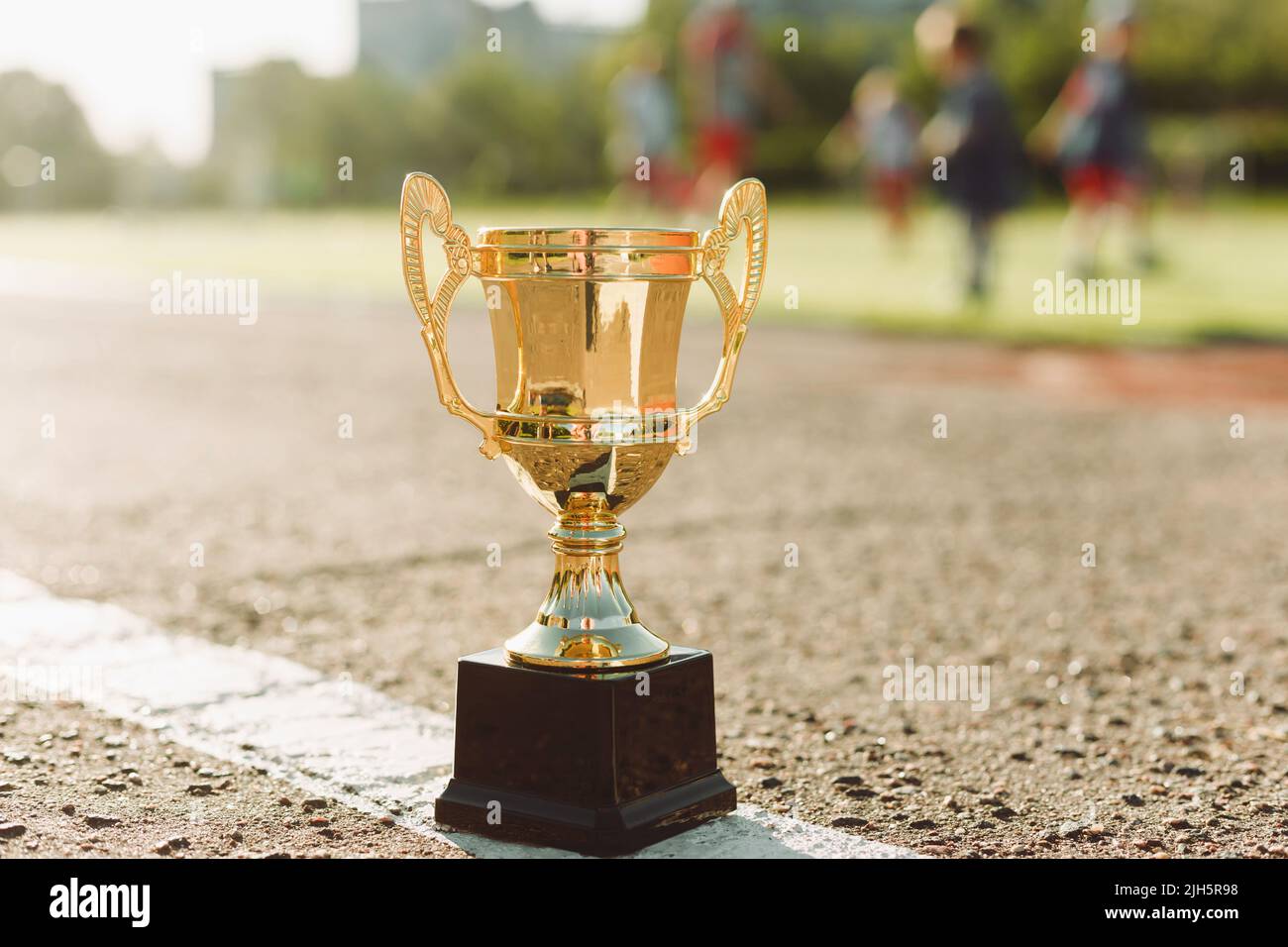 Football golden champion or winner cup with children football ...