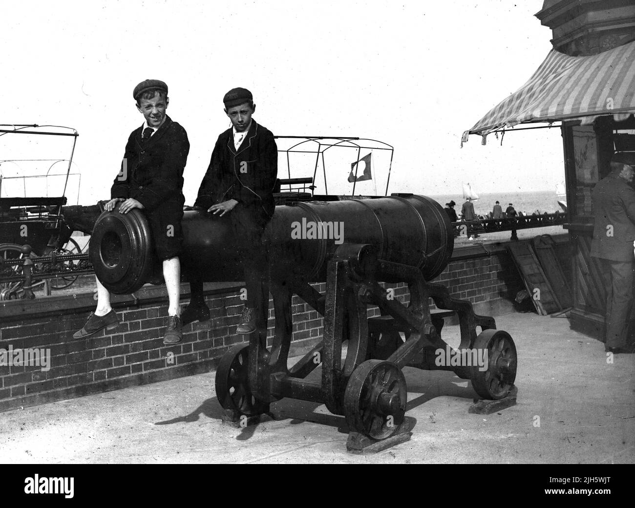 Victorian school boys sitting on cannon at Hastings Britain 1905 Stock ...