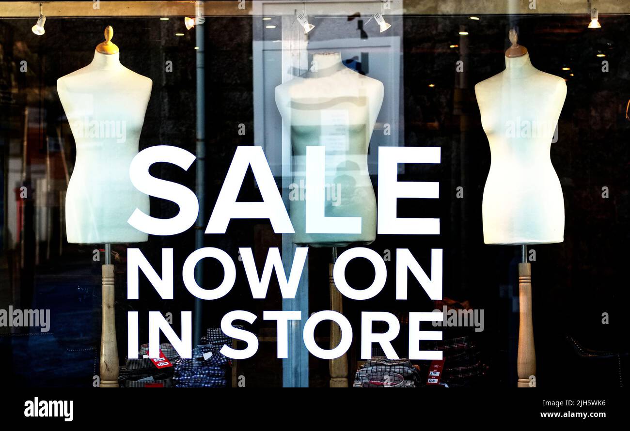 Summer clearance sale now on sign in shop window Stock Photo - Alamy