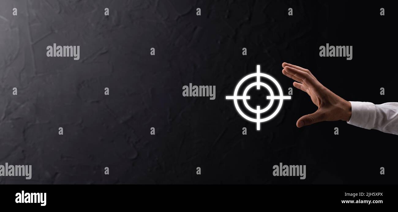 Targeting concept with businessman hand holding target icon dartboard ...