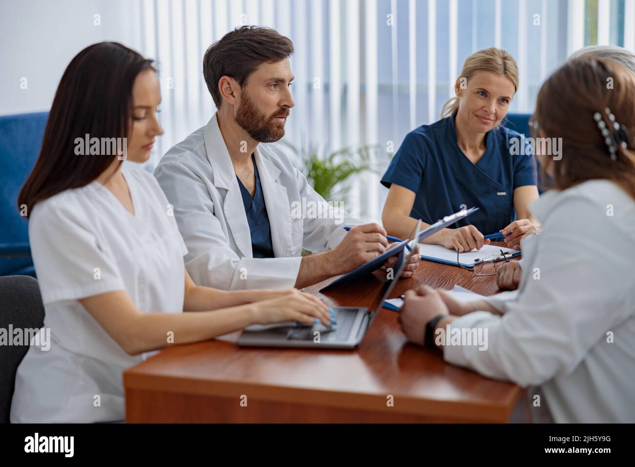 Successful medical doctors are discussing diagnosis during the ...