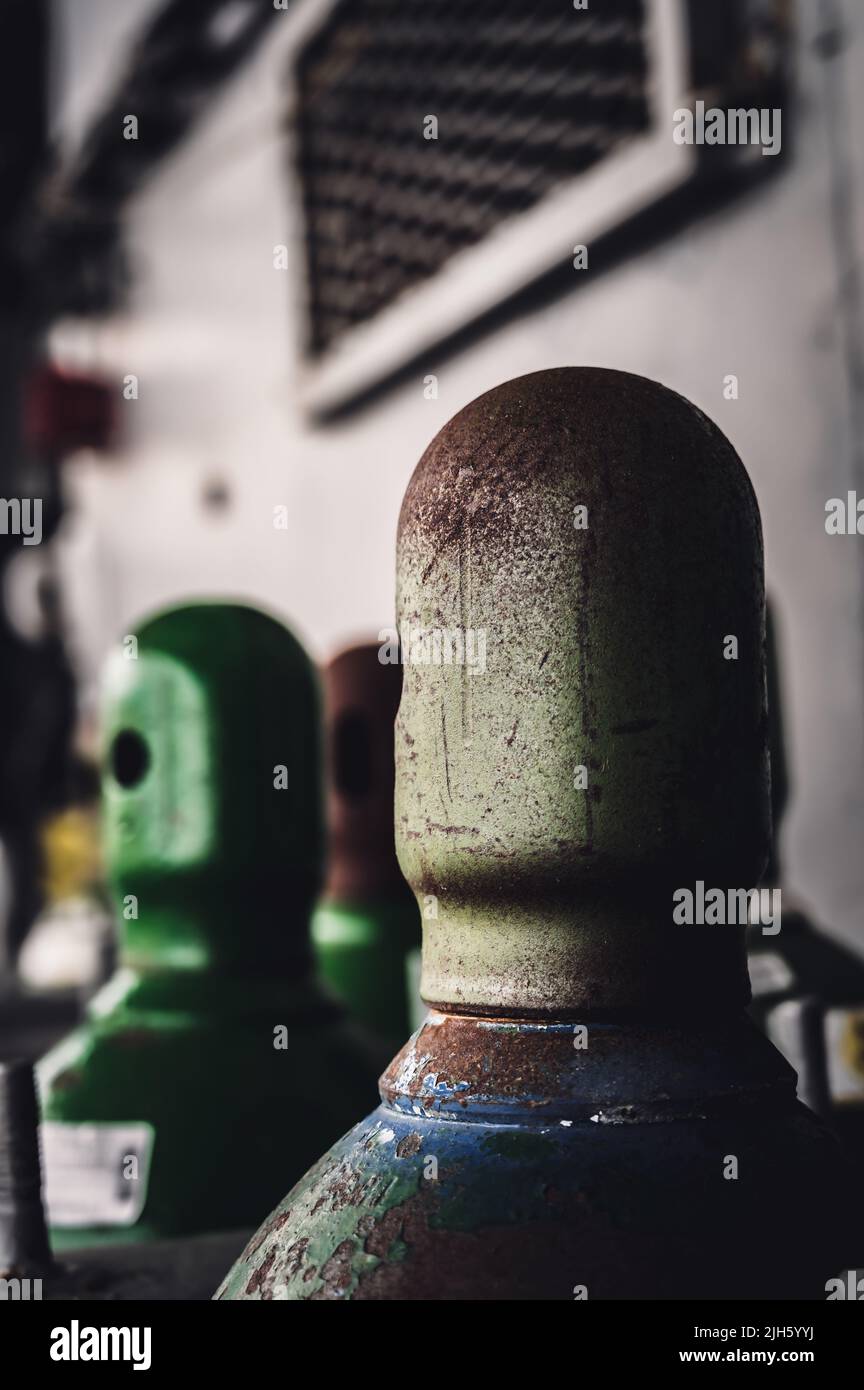 Compressed gas cylinders being stored vertically secured by a metal ...