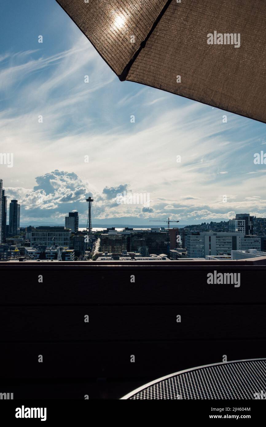 view of downtown Seattle skyline from rooftop deck with sun shining ...