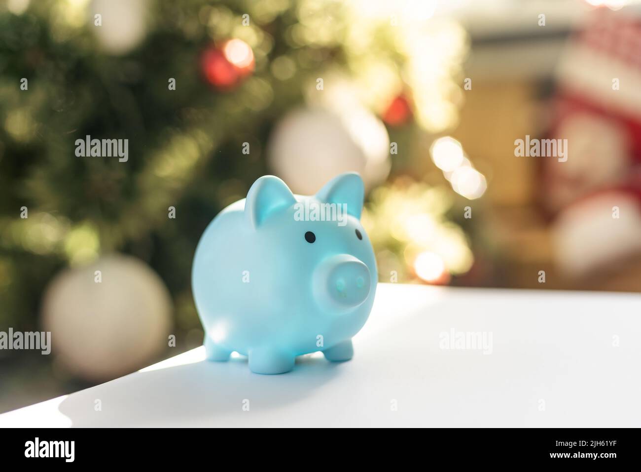 Piggy bank and christmas interior with xmas tree Stock Photo - Alamy