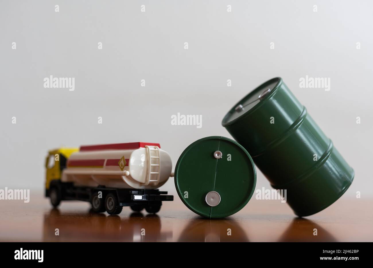 small toy combine with toy oil barrel Stock Photo - Alamy