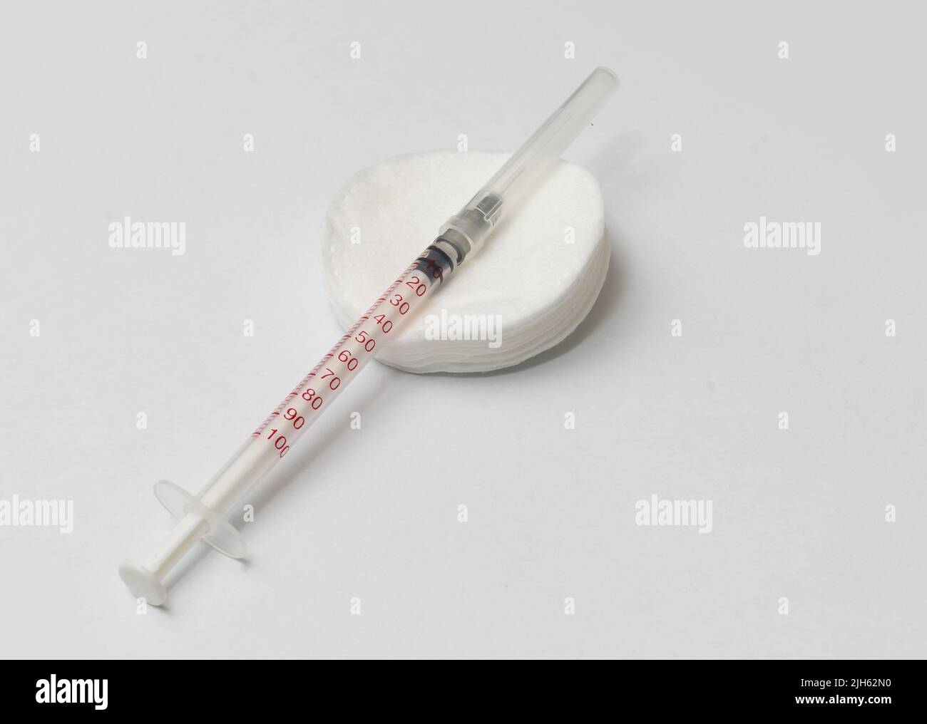 Medical treatment vaccine and syringe for injections on a white ...