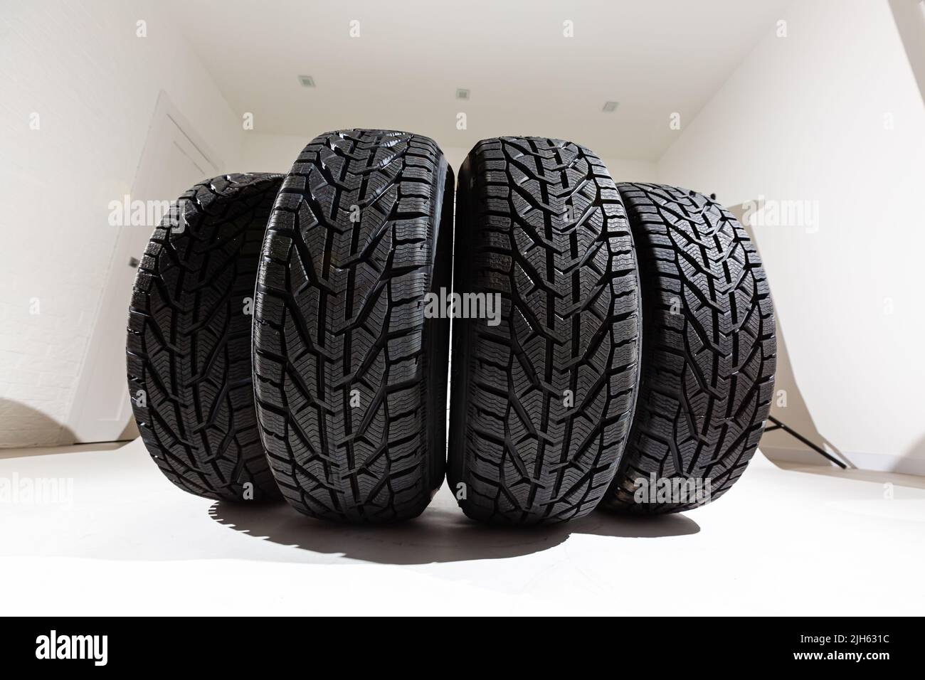 Four tires on the white background Stock Photo - Alamy