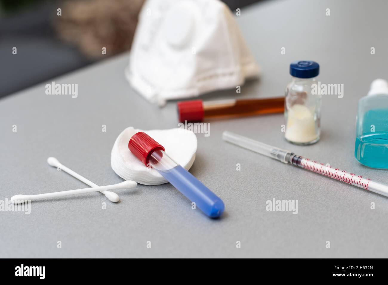 Medical treatment vaccine and syringe for injections on a white ...