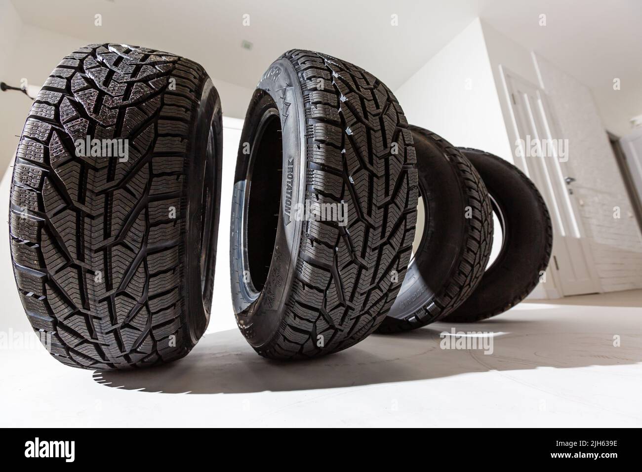 Four tires on the white background Stock Photo - Alamy