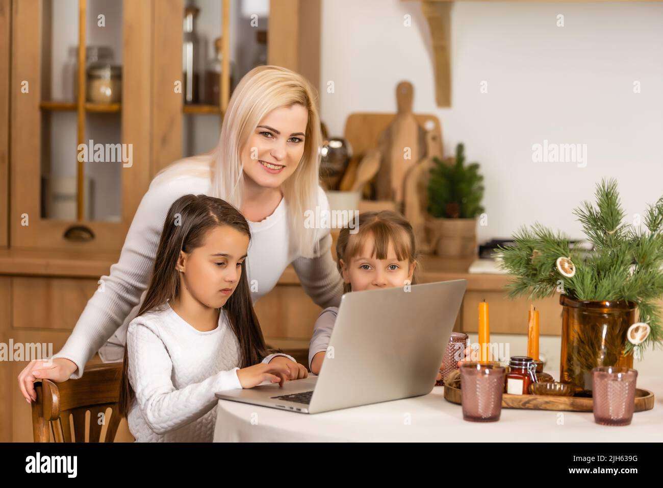 Homeschool. young two little daughters learning internet online, do homework by using computer ...