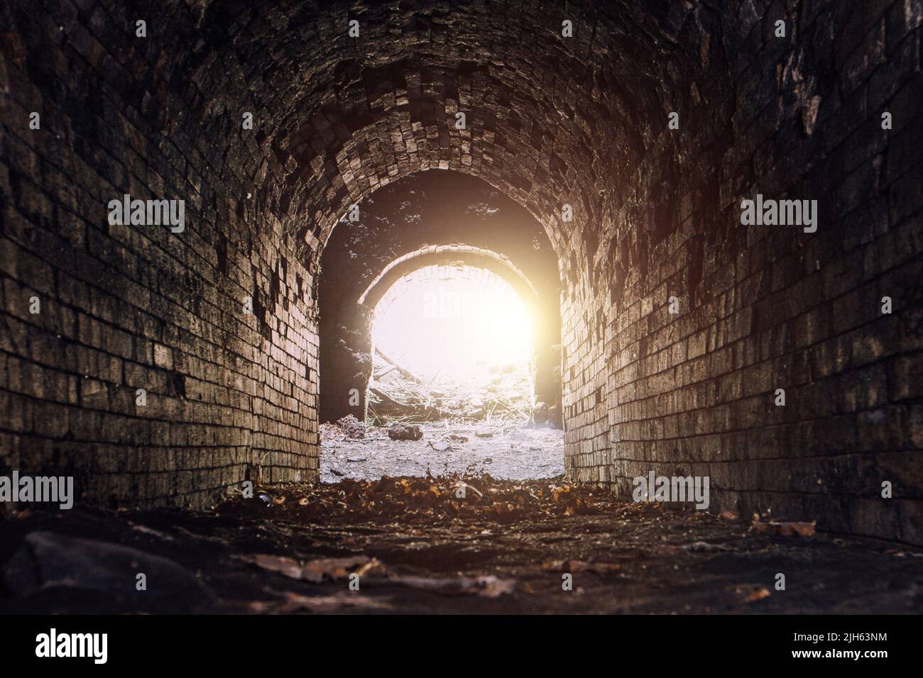 Historical underground red brick passage. Light at the end of tunnel ...