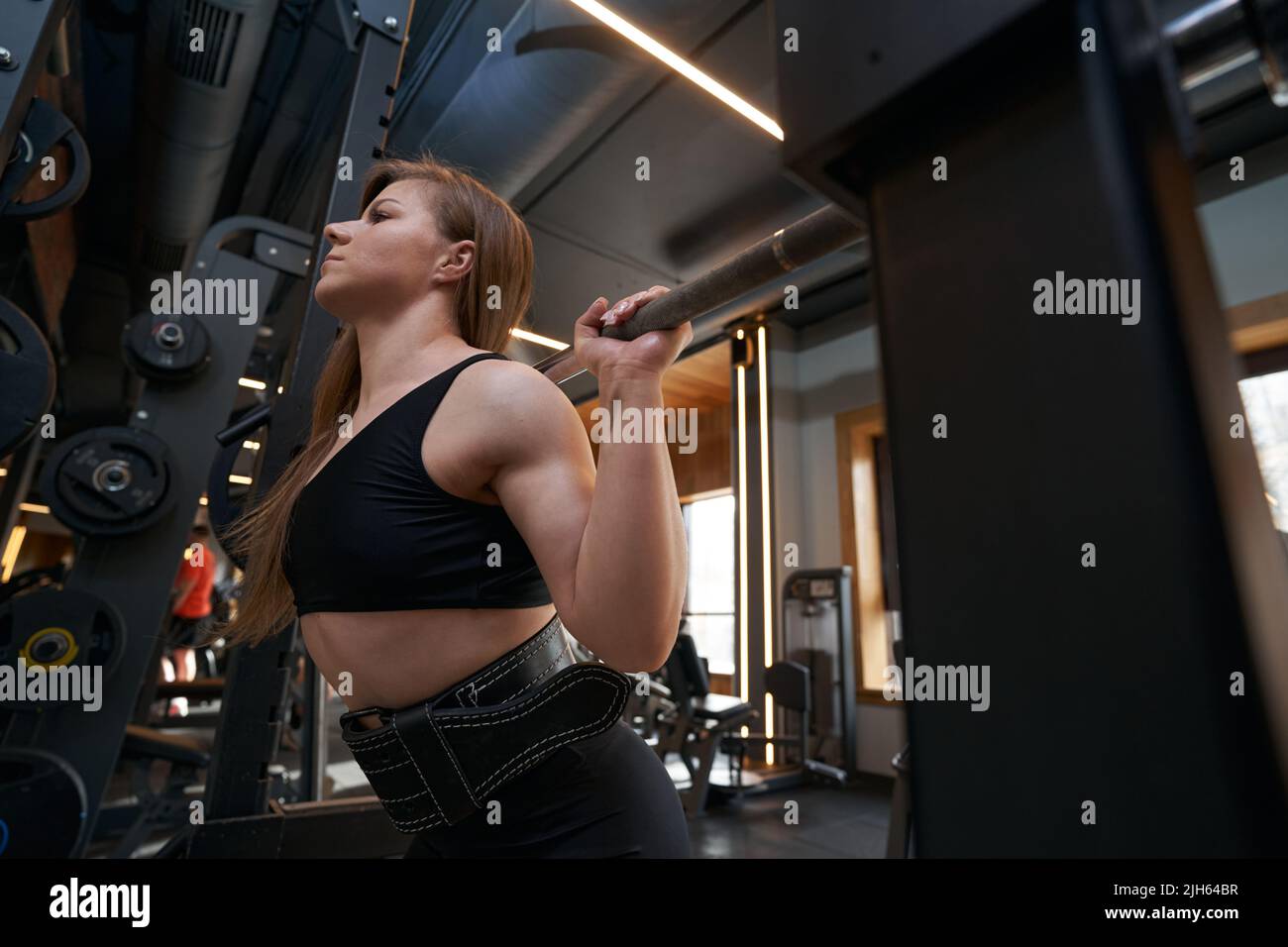 Professional bodybuilder doing weight-lifting exercise in fitness ...