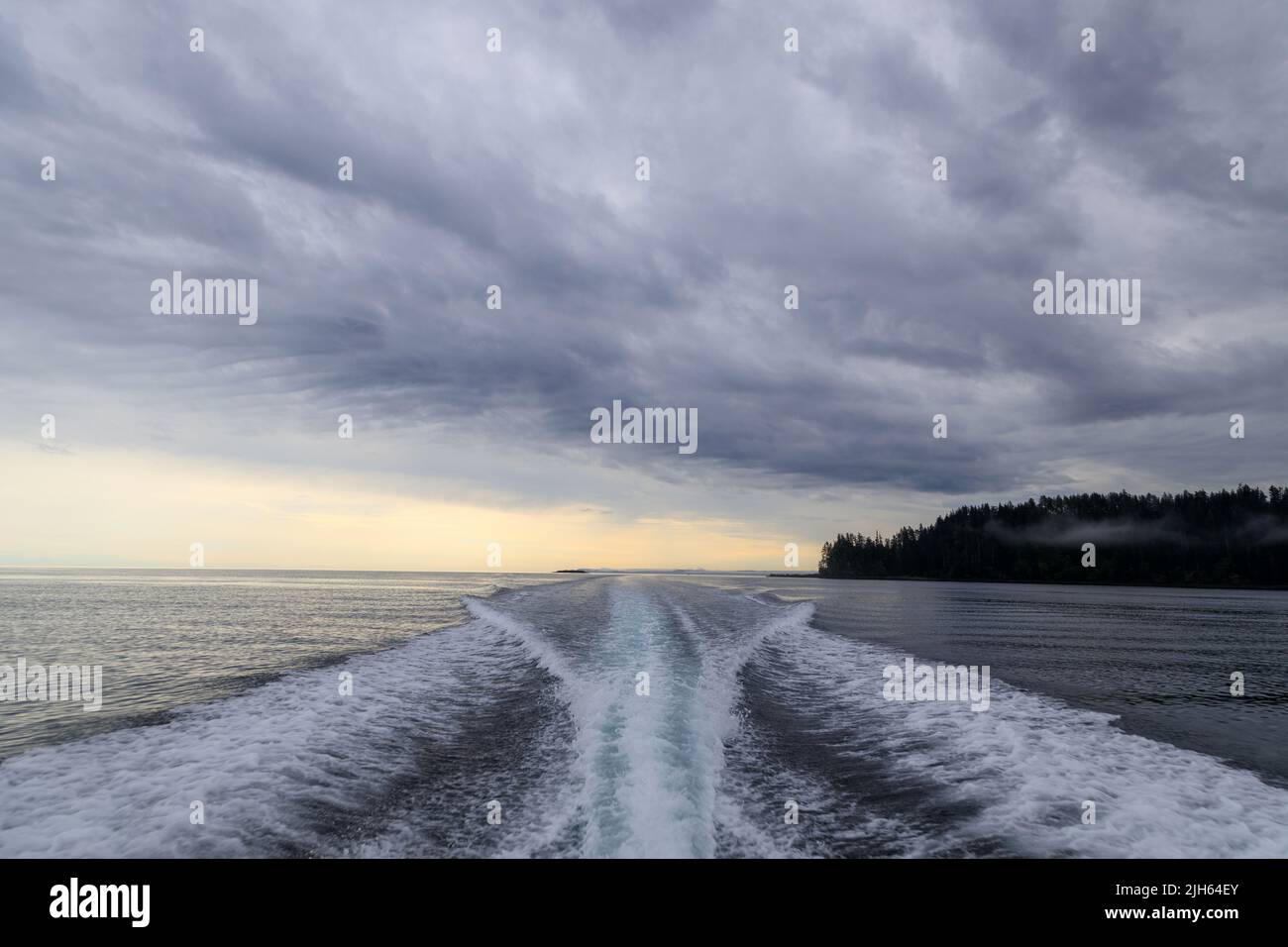 An outboard motor wake from a cruising powerboat on the sea in a ...