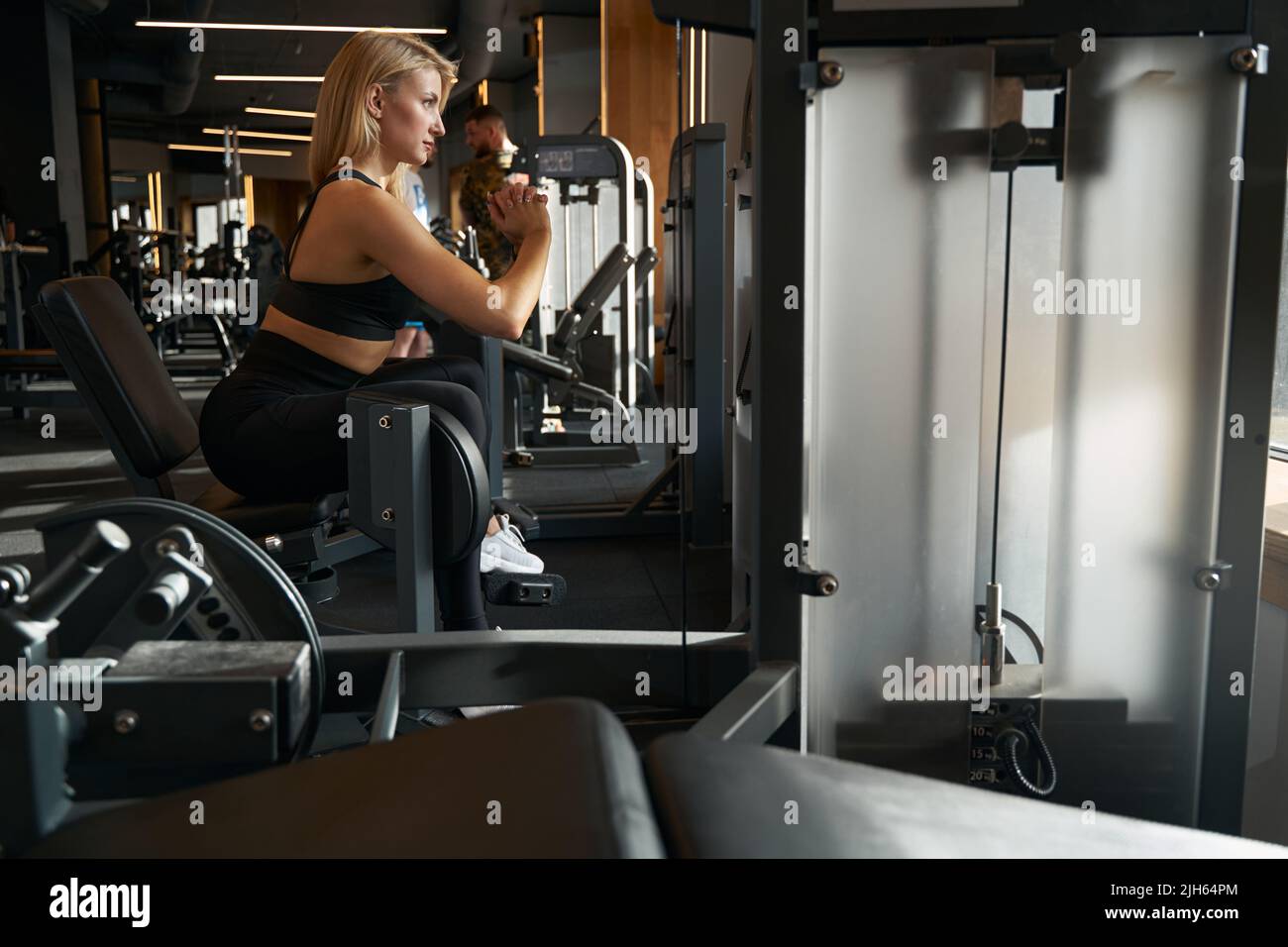 Fit lady doing leg workout in fitness studio Stock Photo - Alamy
