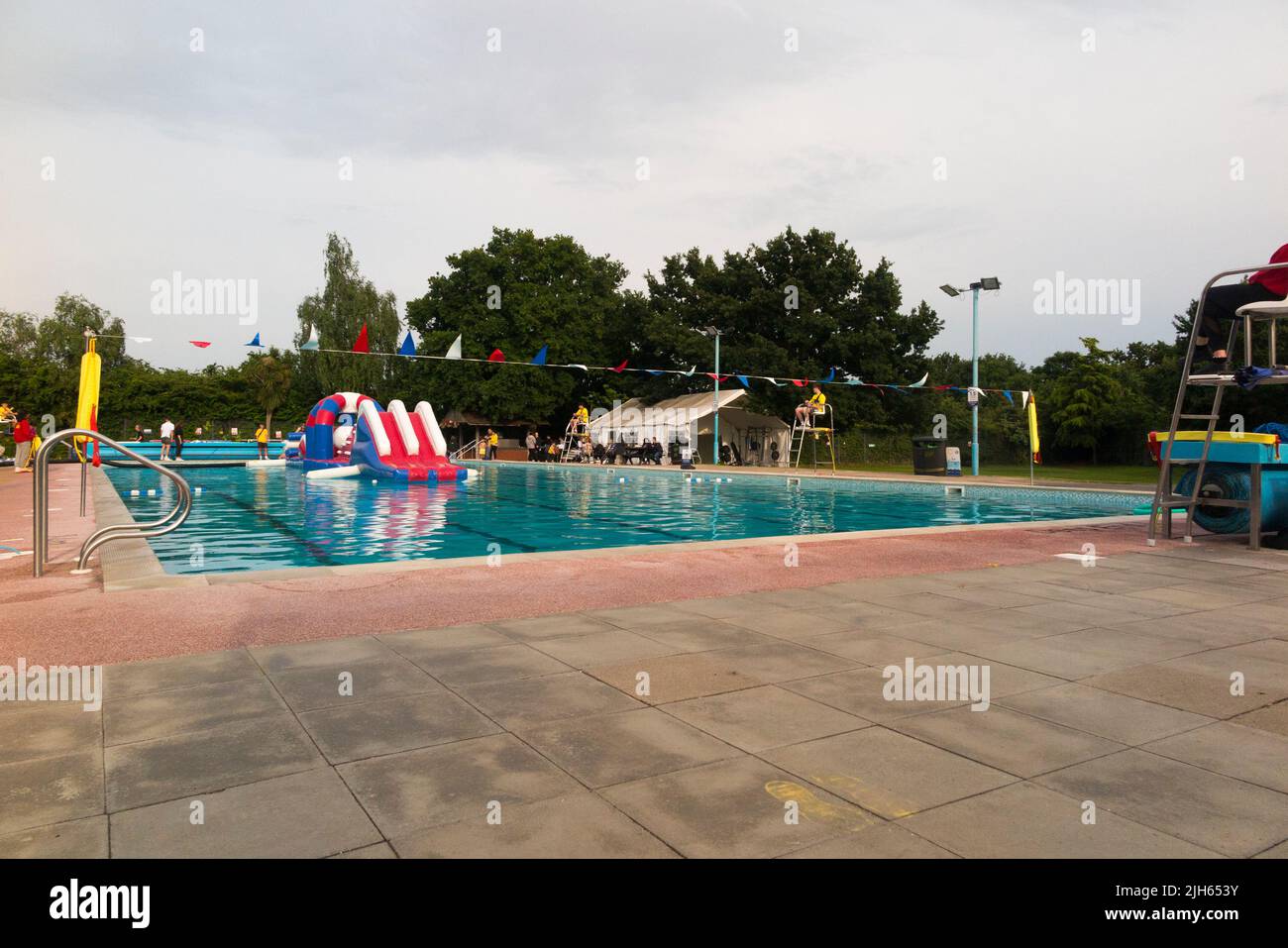 Hampton Open Air swimming pool on a warm and sunny evening with sunset ...