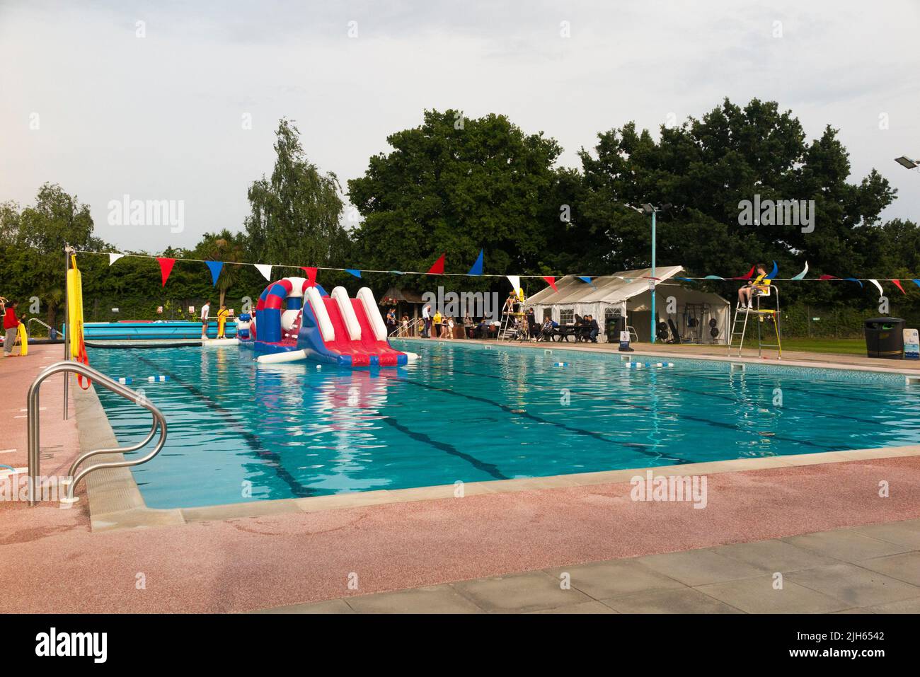 Hampton Open Air swimming pool on a warm and sunny evening with sunset ...