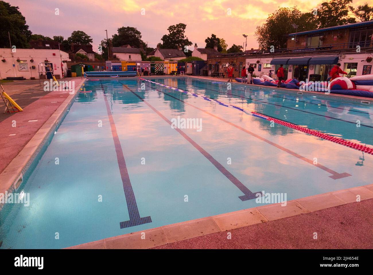 Hampton Open Air swimming pool on a warm and sunny evening with sunset ...