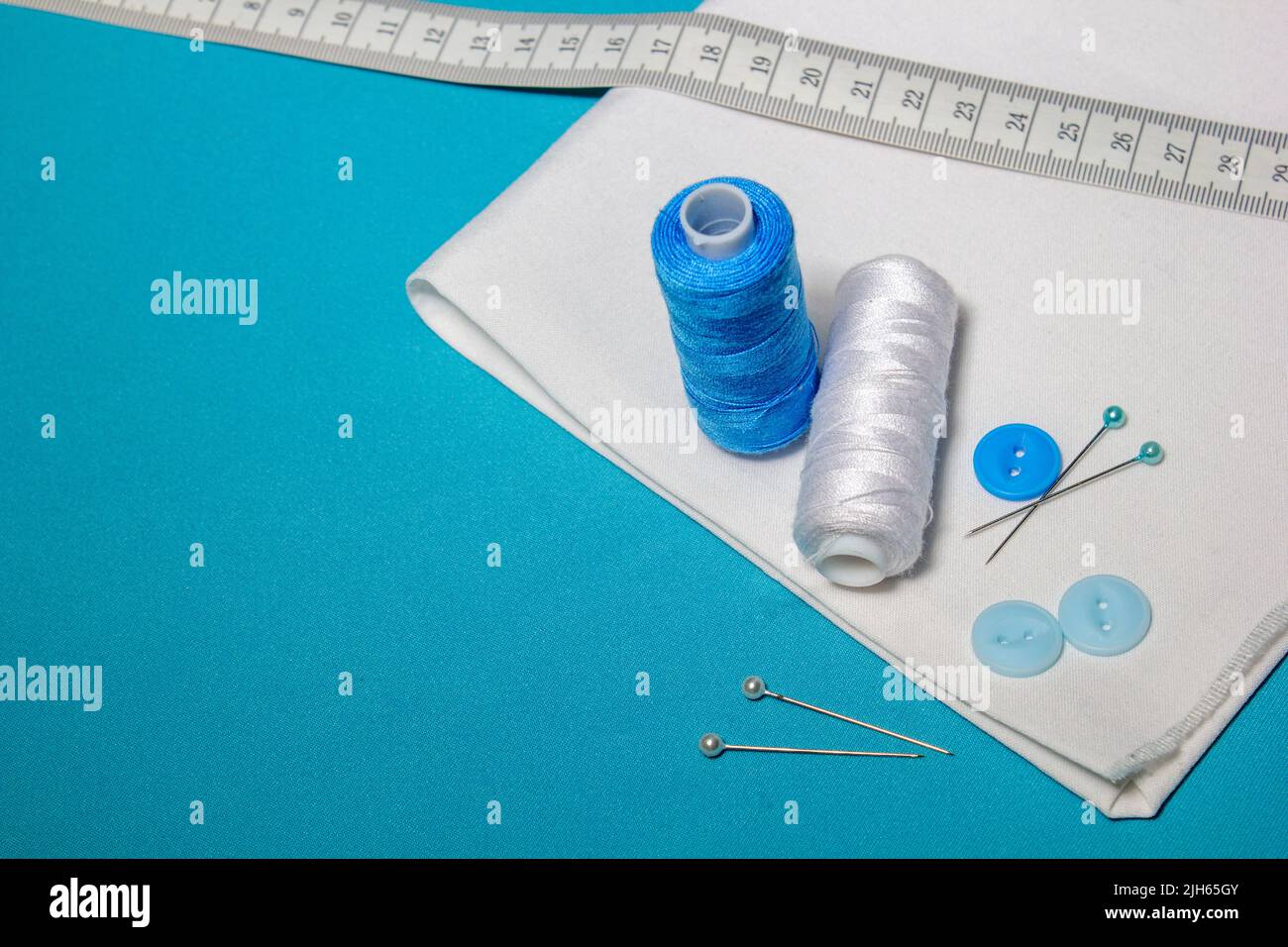 Blue textured background with sewing tools, copy space on background ...