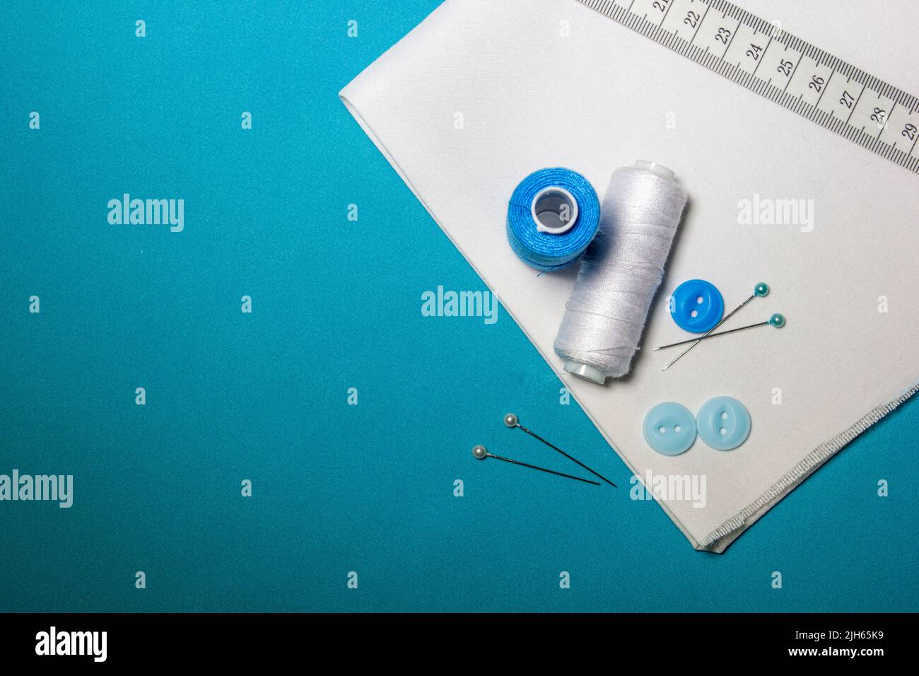 Blue textured background with sewing tools, copy space on background ...