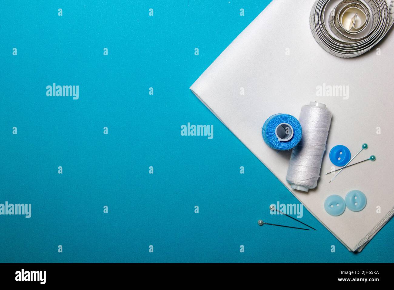 Blue textured background with sewing tools, copy space on background ...