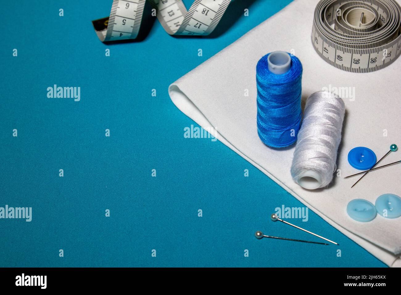 Blue textured background with sewing tools, copy space on background ...