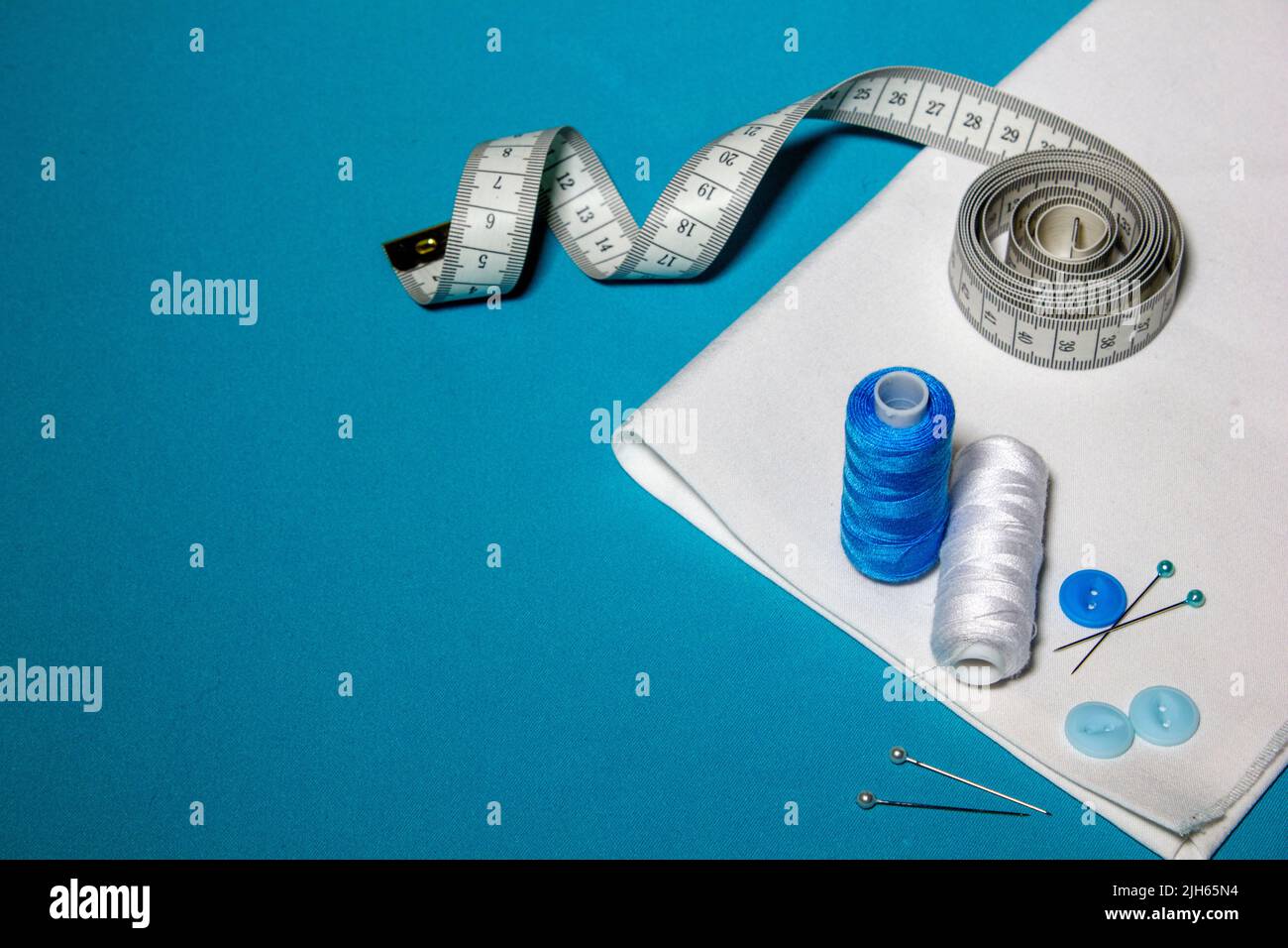 Blue textured background with sewing tools, copy space on background ...