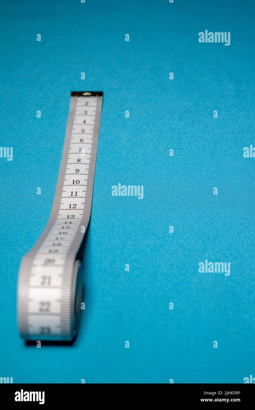 Top view of white soft measuring tape. Minimalist flat lay image of ...