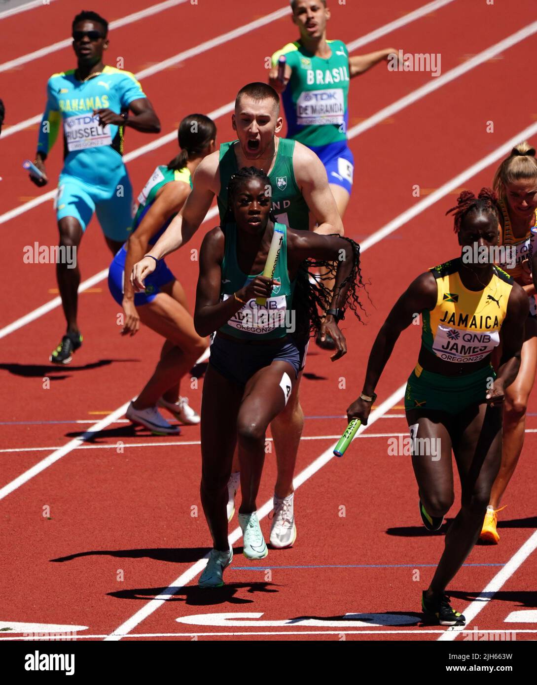 Ireland's Rhsidat Adeleke (left) receives the baton from Jack Raftery ...