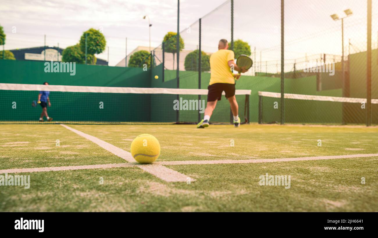 Professional monitor of padel jump to the ball with a black racket ...