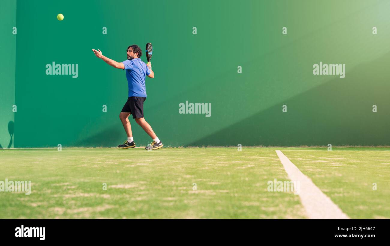 Monitor practicing paddle sport on the outdoor court. Man teaching ...