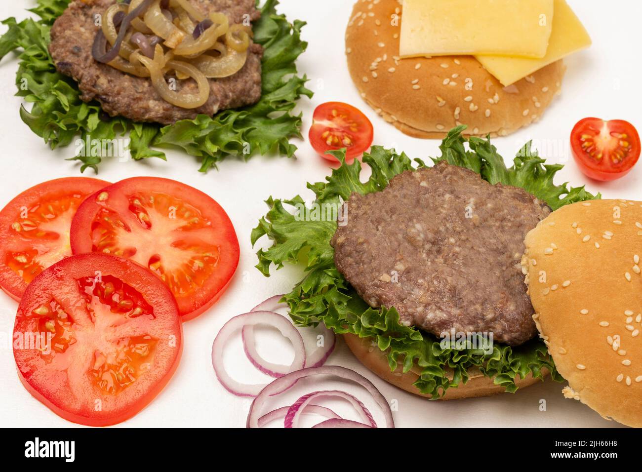 Fried burger bun on lettuce leaf, fried burger with cheese and fried ...