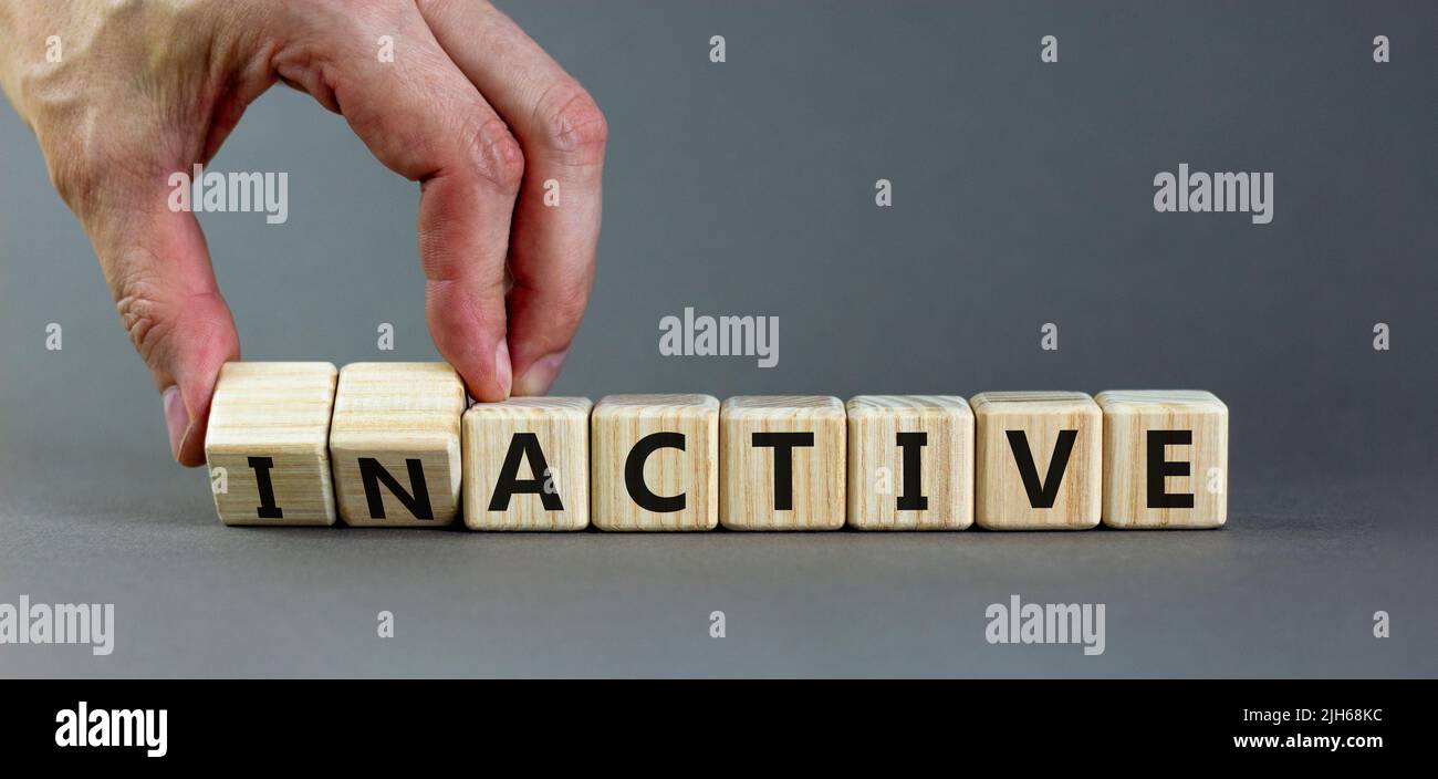 Active or inactive symbol. Businessman turns wooden cubes and changes ...