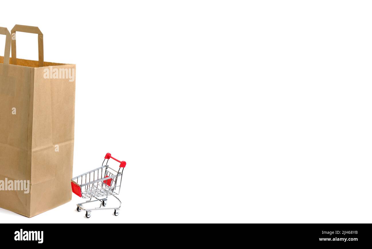 Paper bag and shopping cart white background Stock Photo - Alamy