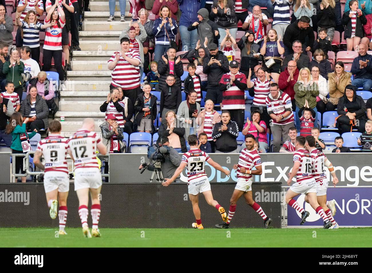 Bevan French #1 of Wigan Warriors celebrates with Jai Field in front of ...