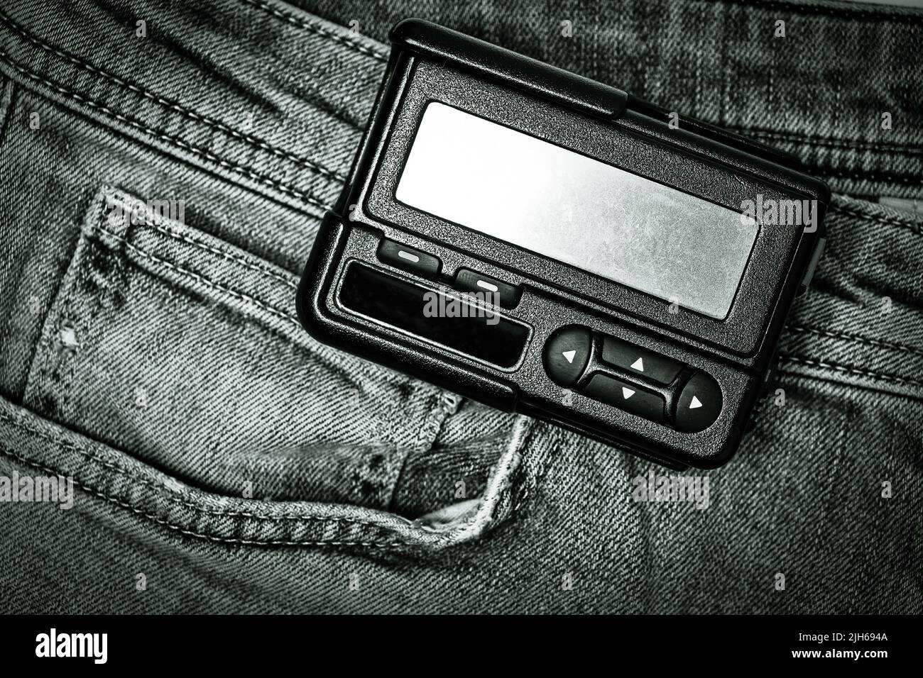 Pager is an old retro gadget for communication on jeans Stock Photo - Alamy
