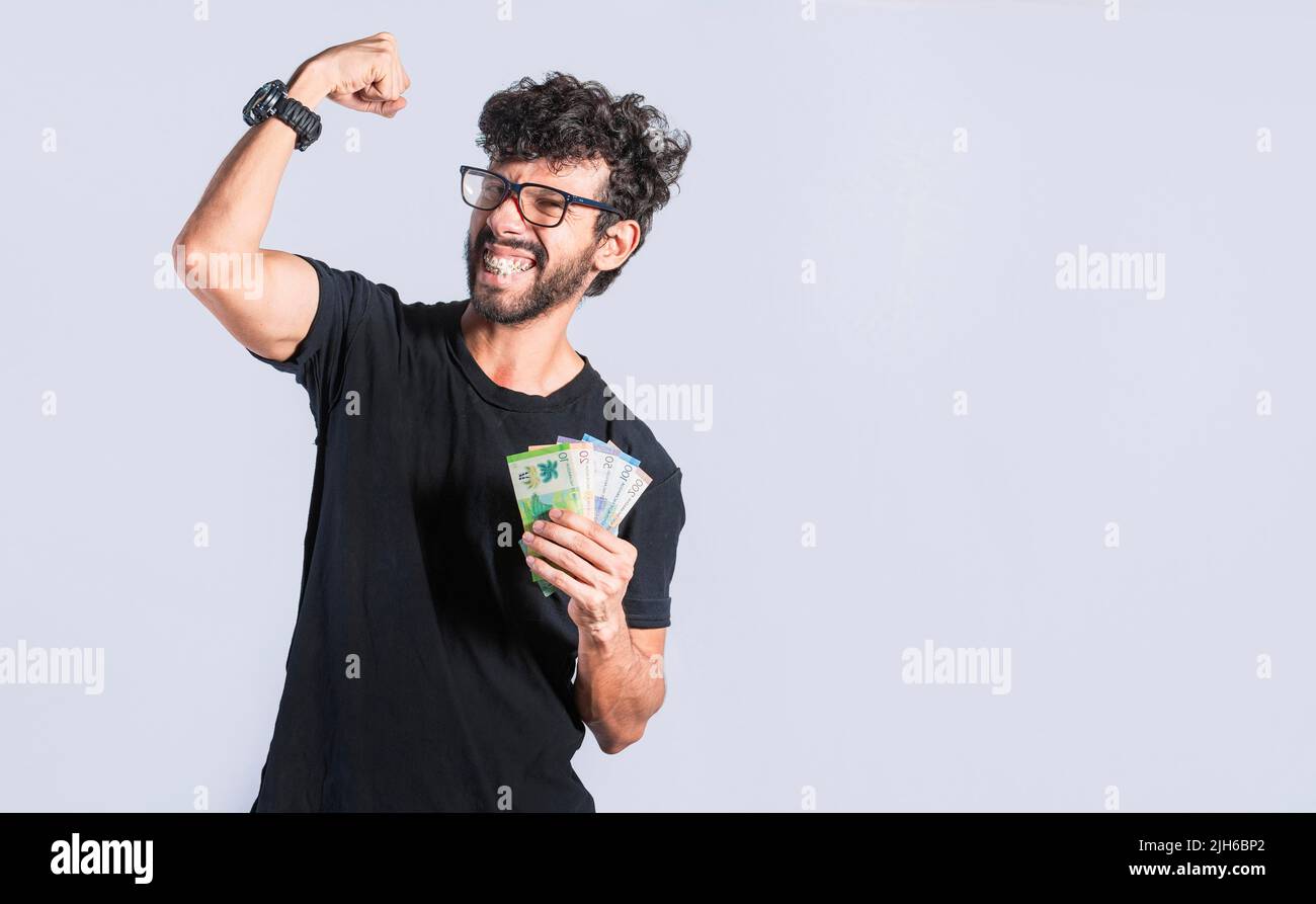 Excited man with money in his hand isolated. Happy man with money ...