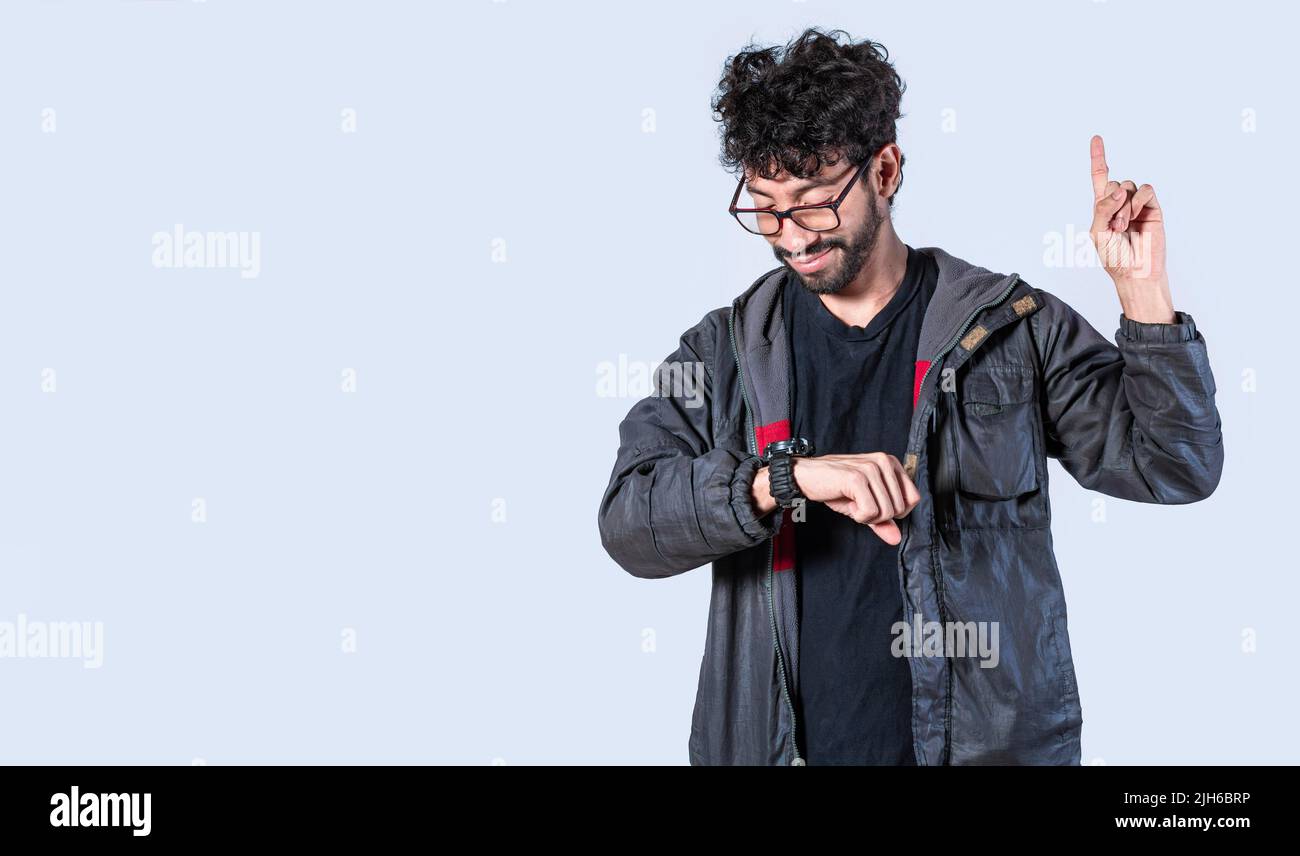 Isolated person looking at his watch and raising his finger, A man ...