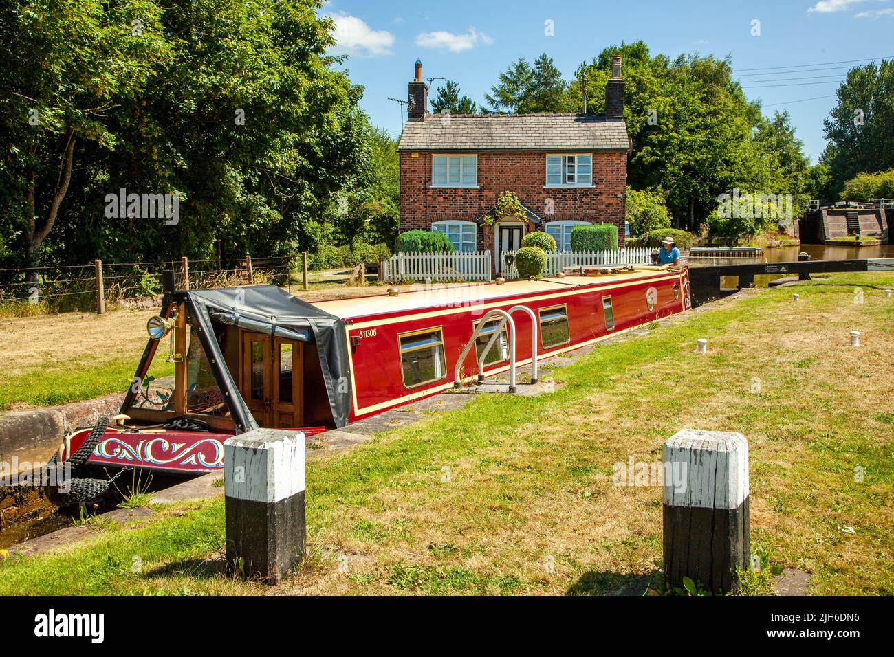 Canal narrowboat passing through locks on the Trent and Mersey canal as ...