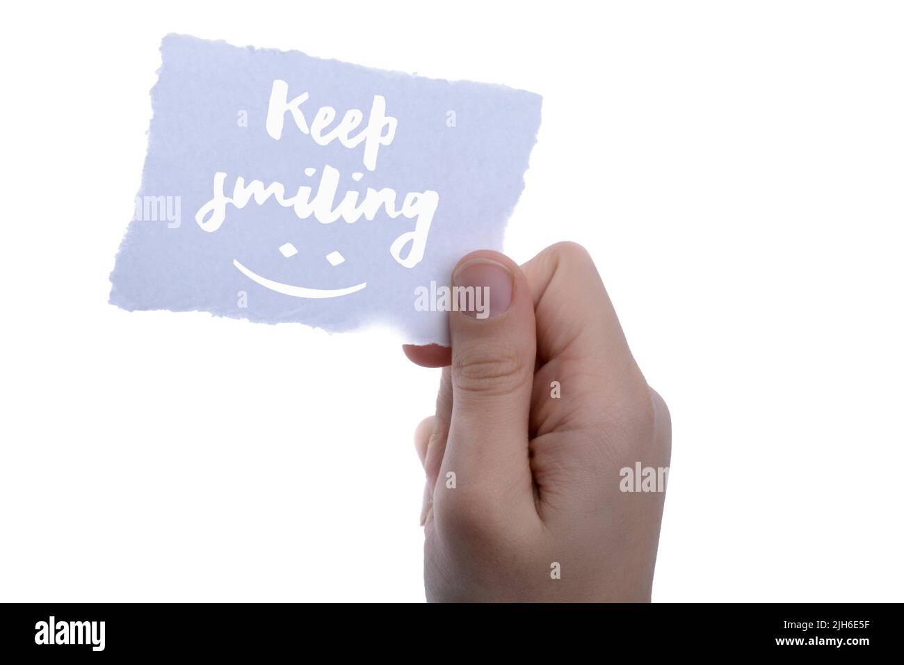 Keep smiling text on paper on a white background Stock Photo - Alamy