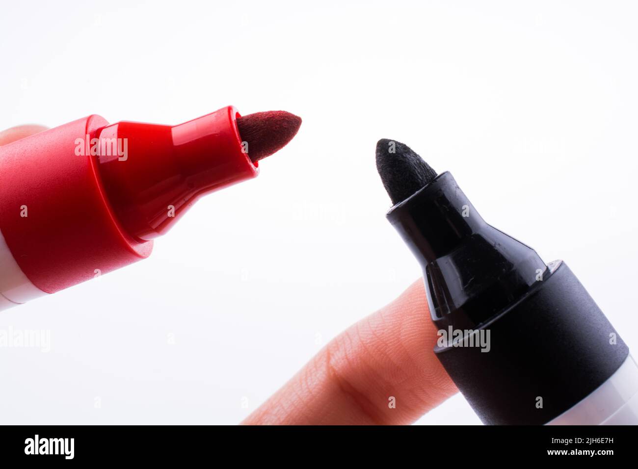 Hand holding Color markers face to face on a white background Stock ...