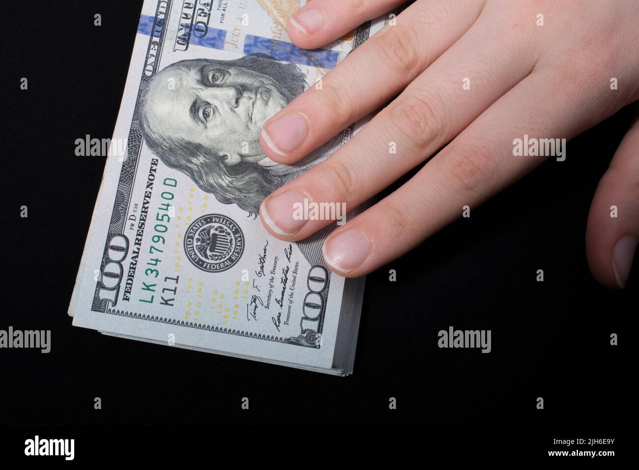 Hand holding American dollar banknotes isolated on white background ...