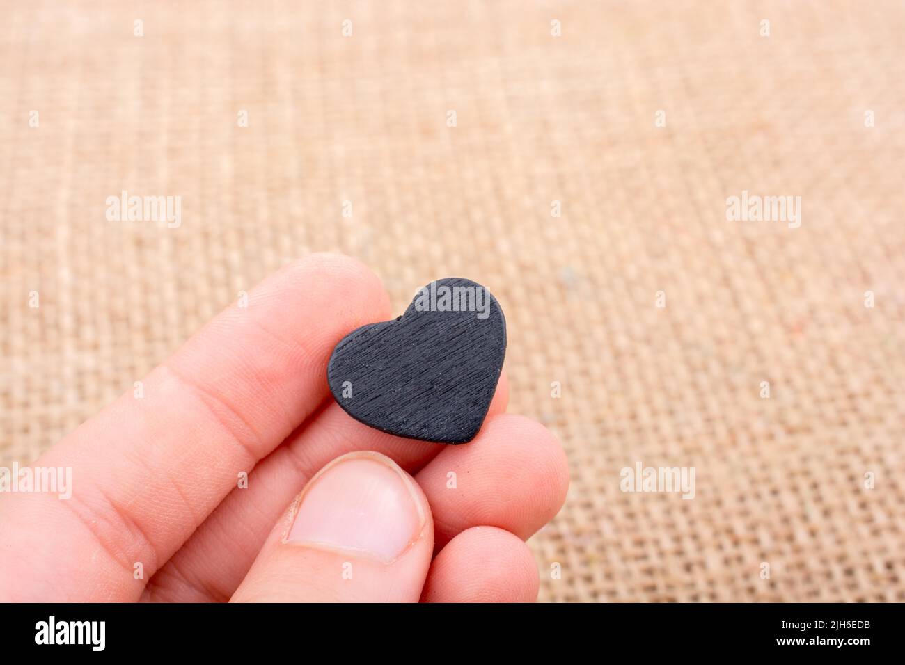Heart shaped object in hand on canvas Stock Photo - Alamy