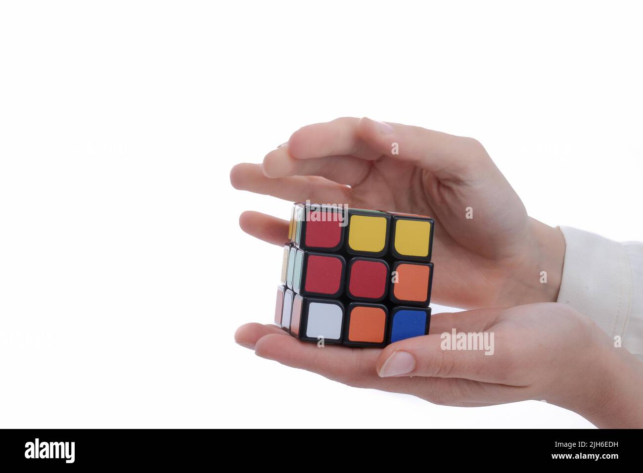 Child holding a Rubik's cube in hand on a white background Stock Photo ...