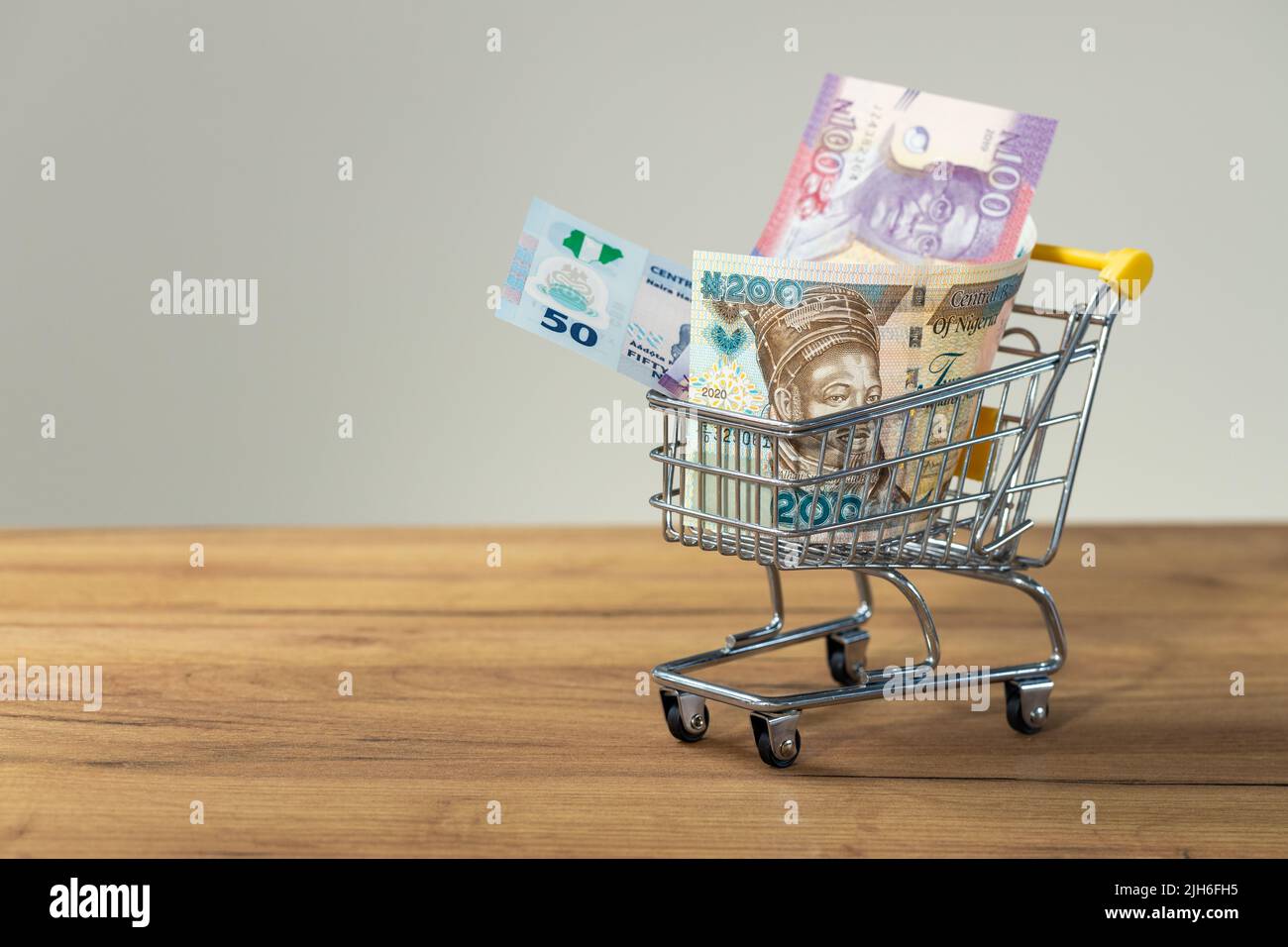 Nigerian money, shopping cart, The concept of high prices, inflation ...