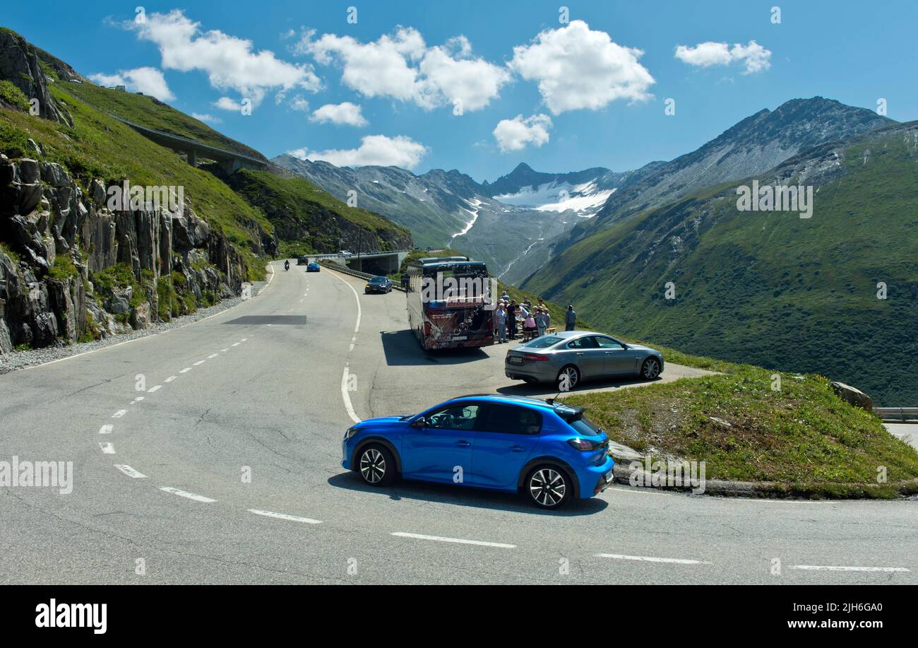 Rest area with coach and cars on the pass road to the Furka Pass ...