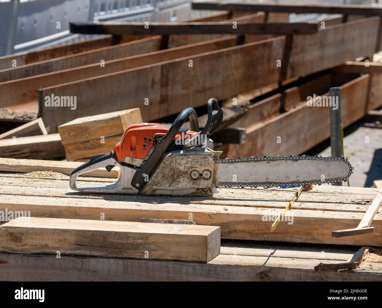 Wood pile with chain saw at a road construction site, Berlin, Germany ...