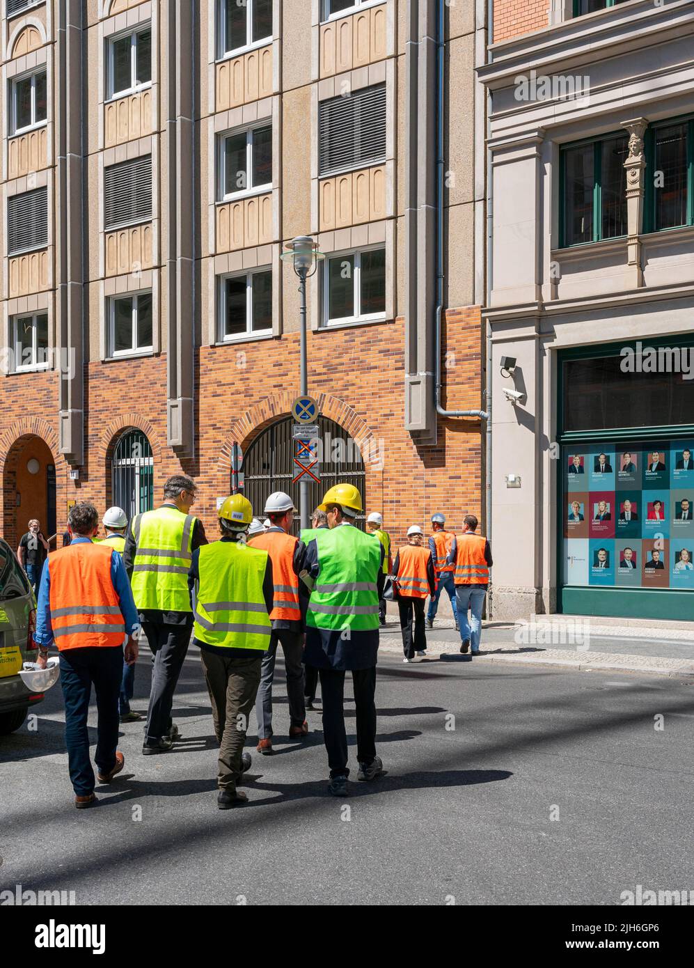Construction workers with safety waistcoats in green and orange, Berlin ...